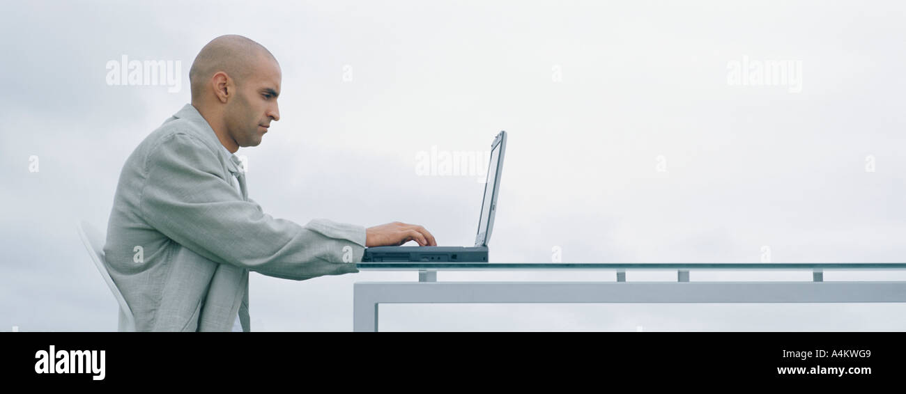 Side view man sitting using hi-res stock photography and images - Alamy