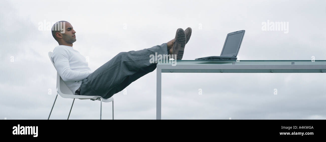 Man sitting on chair with leg up hi-res stock photography and images ...