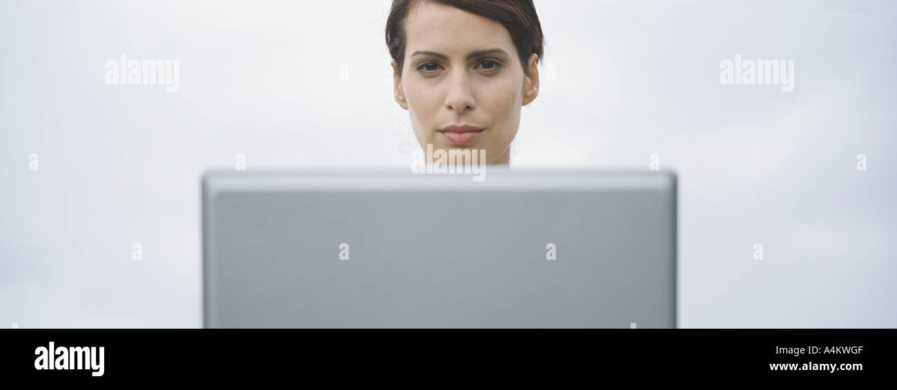 Woman looking over edge of computer hi-res stock photography and images ...