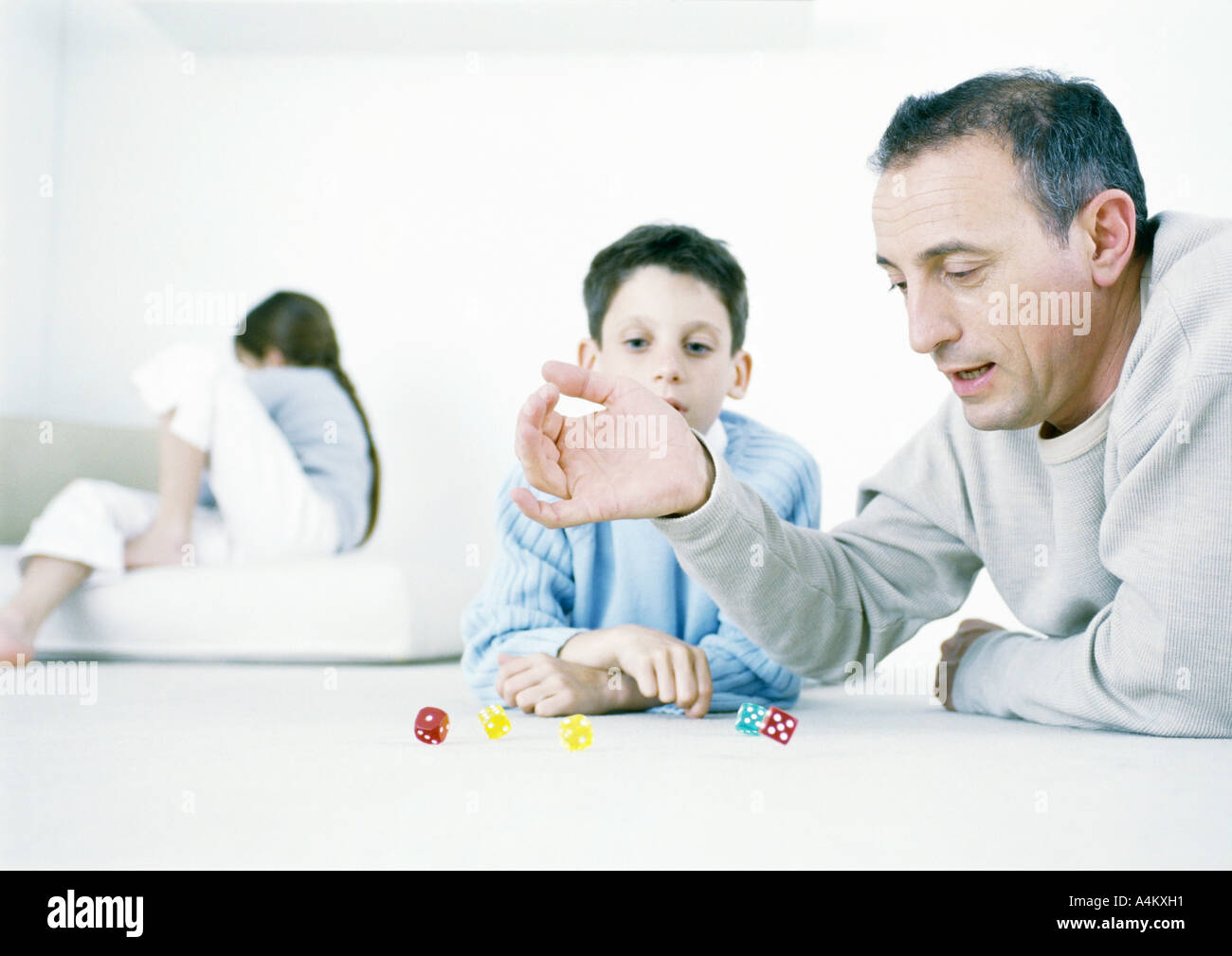 Three boys playing dice hi-res stock photography and images - Alamy