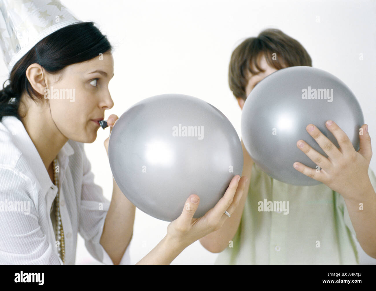Women blowing up balloon hi-res stock photography and images - Alamy