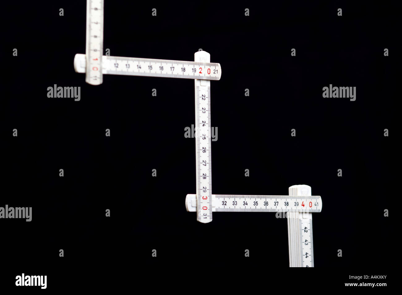 Folding rule on black background Stock Photo - Alamy