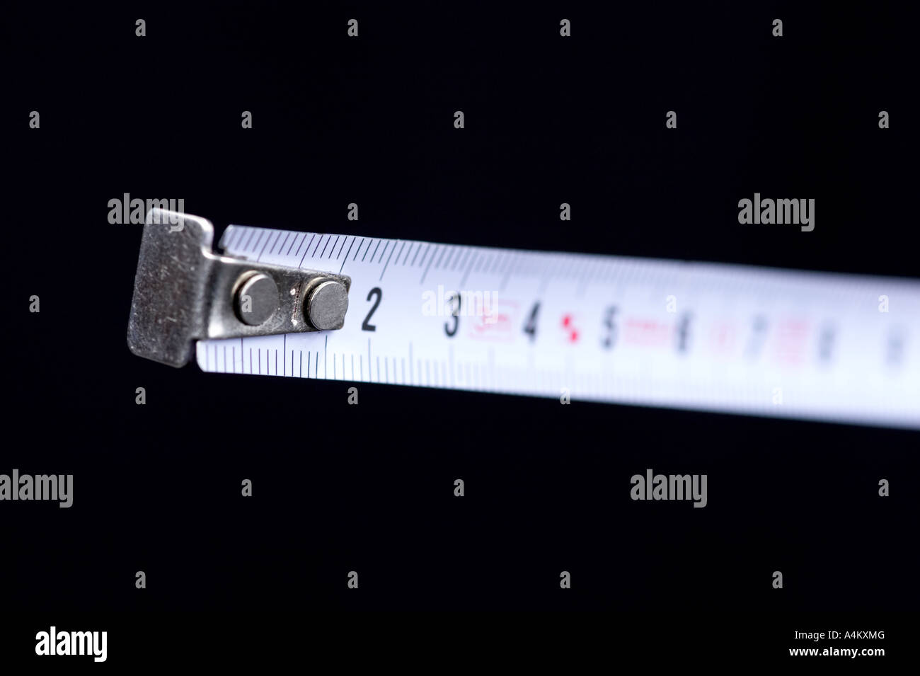 Measuring tape on black background Stock Photo - Alamy