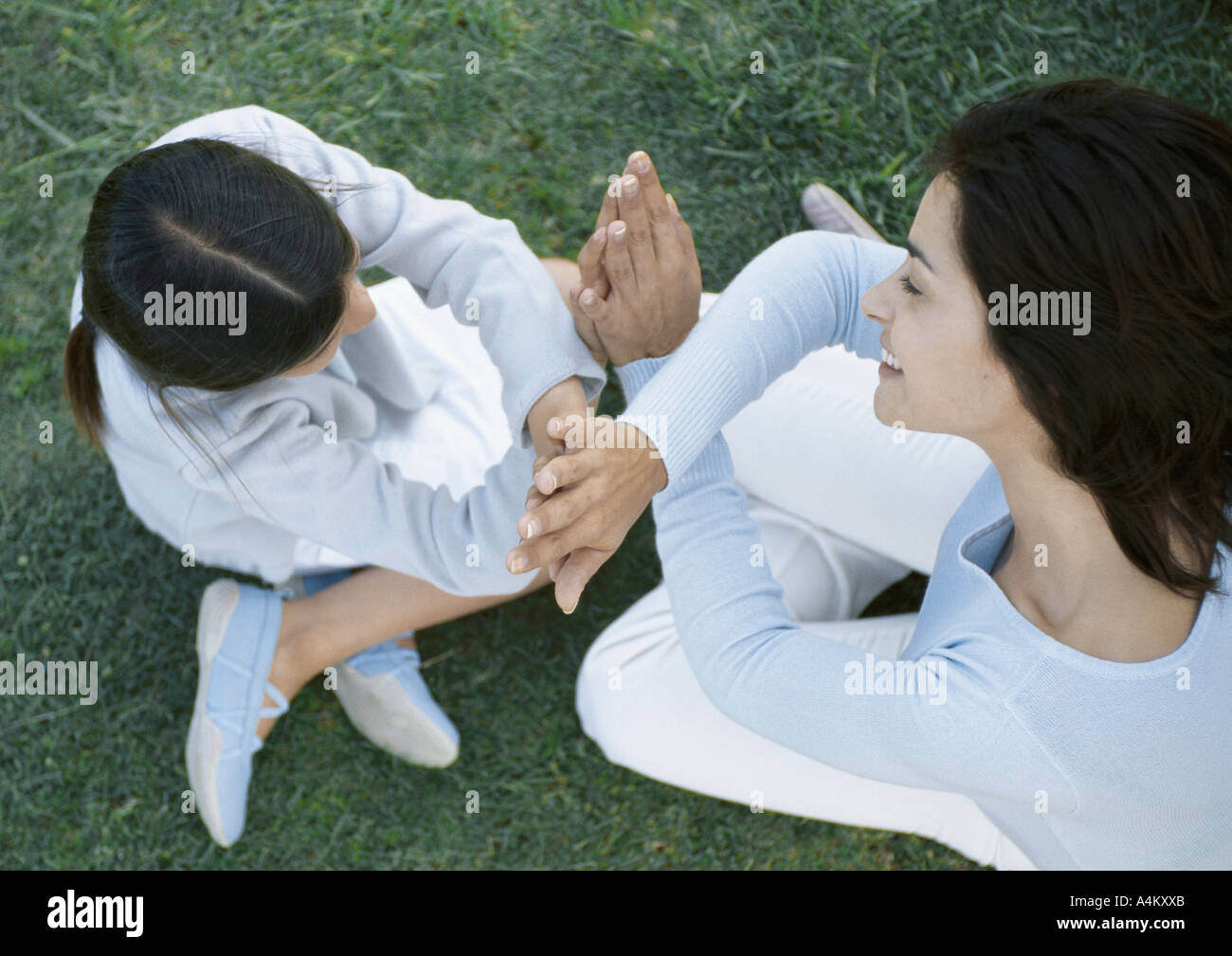 Mother and daughter playing clapping game Stock Photo - Alamy