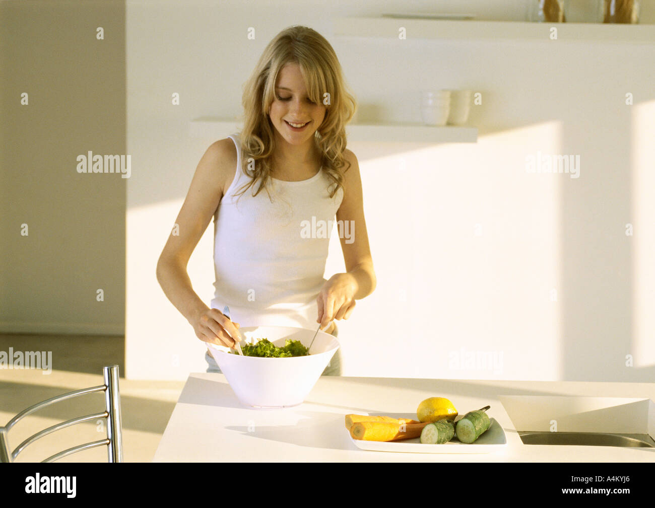 Teen girl preparing meal in kitchen Stock Photo - Alamy