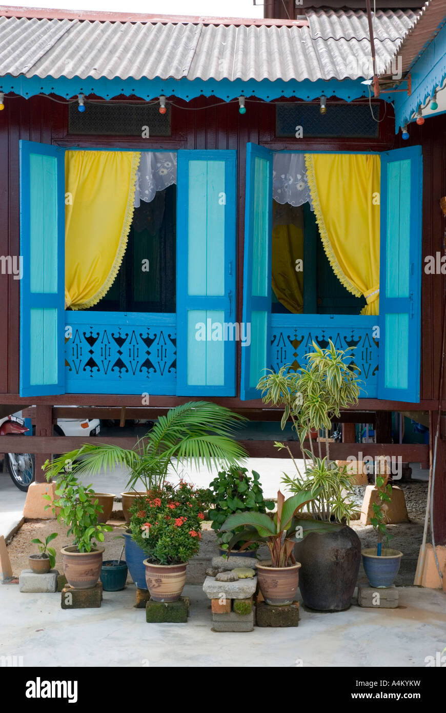 Brightly painted windows of a typical Malay house in an inner city ...