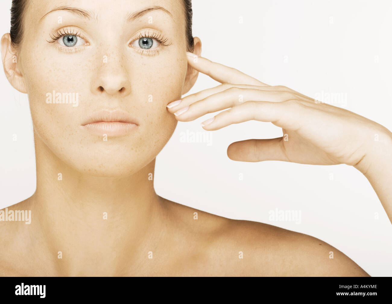 Woman touching face Stock Photo - Alamy