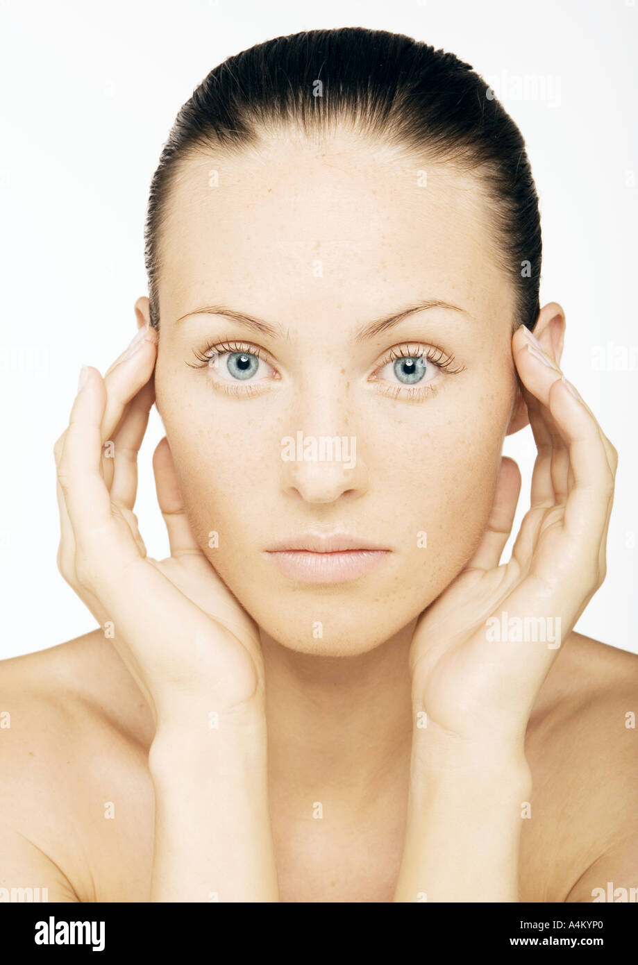 Woman's face with hands at side of head, portrait Stock Photo - Alamy