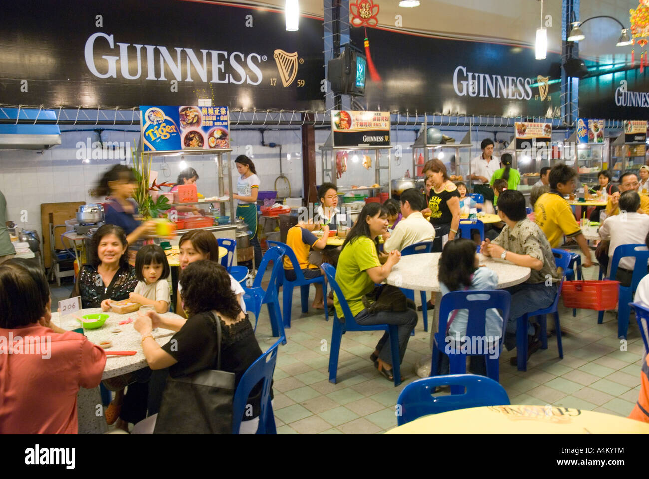 A bustling food court with Guinness advertising in Ipoh Malaysia Stock ...