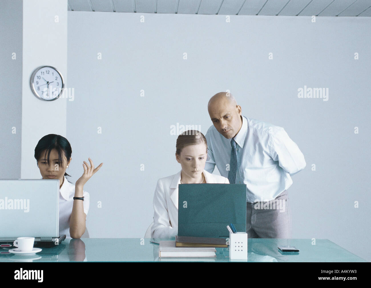 Boss looking over employees shoulder hi-res stock photography and ...