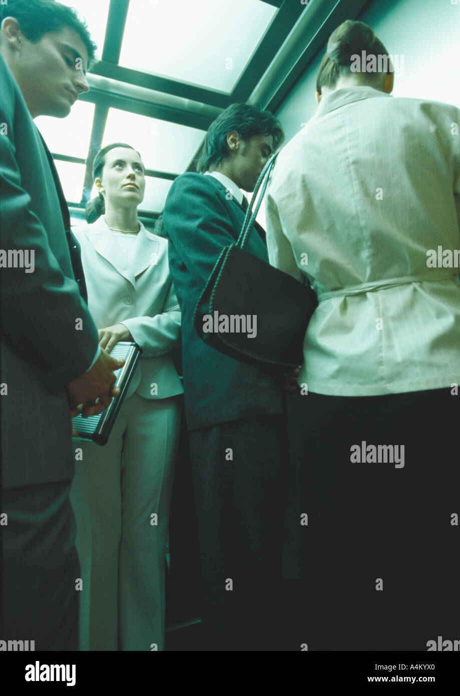 Professionals in elevator, low angle view Stock Photo - Alamy