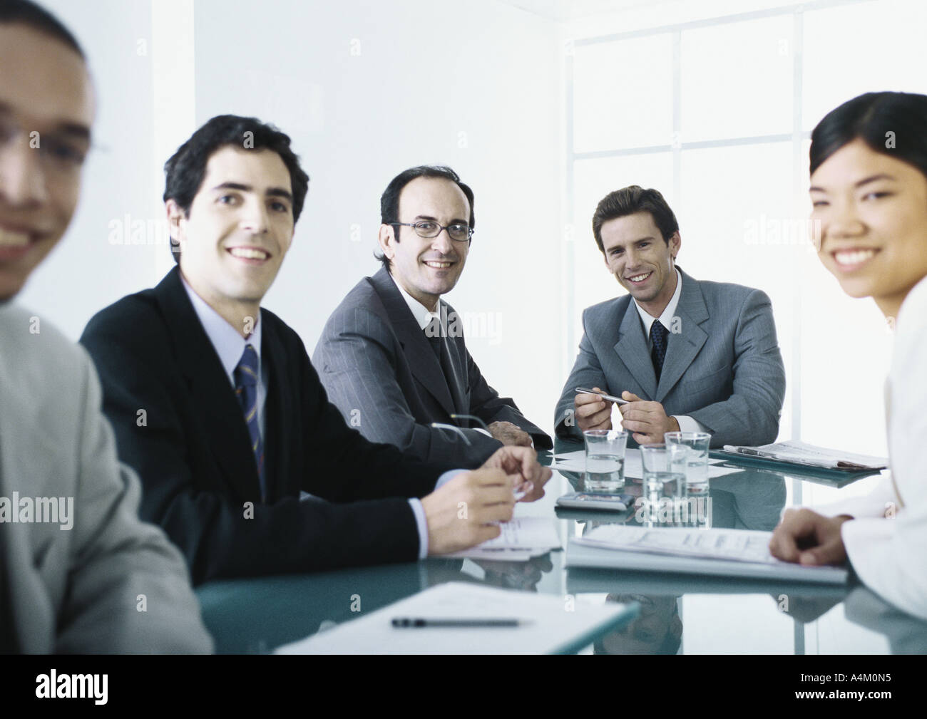 Executives sitting around conference table hi-res stock photography and ...