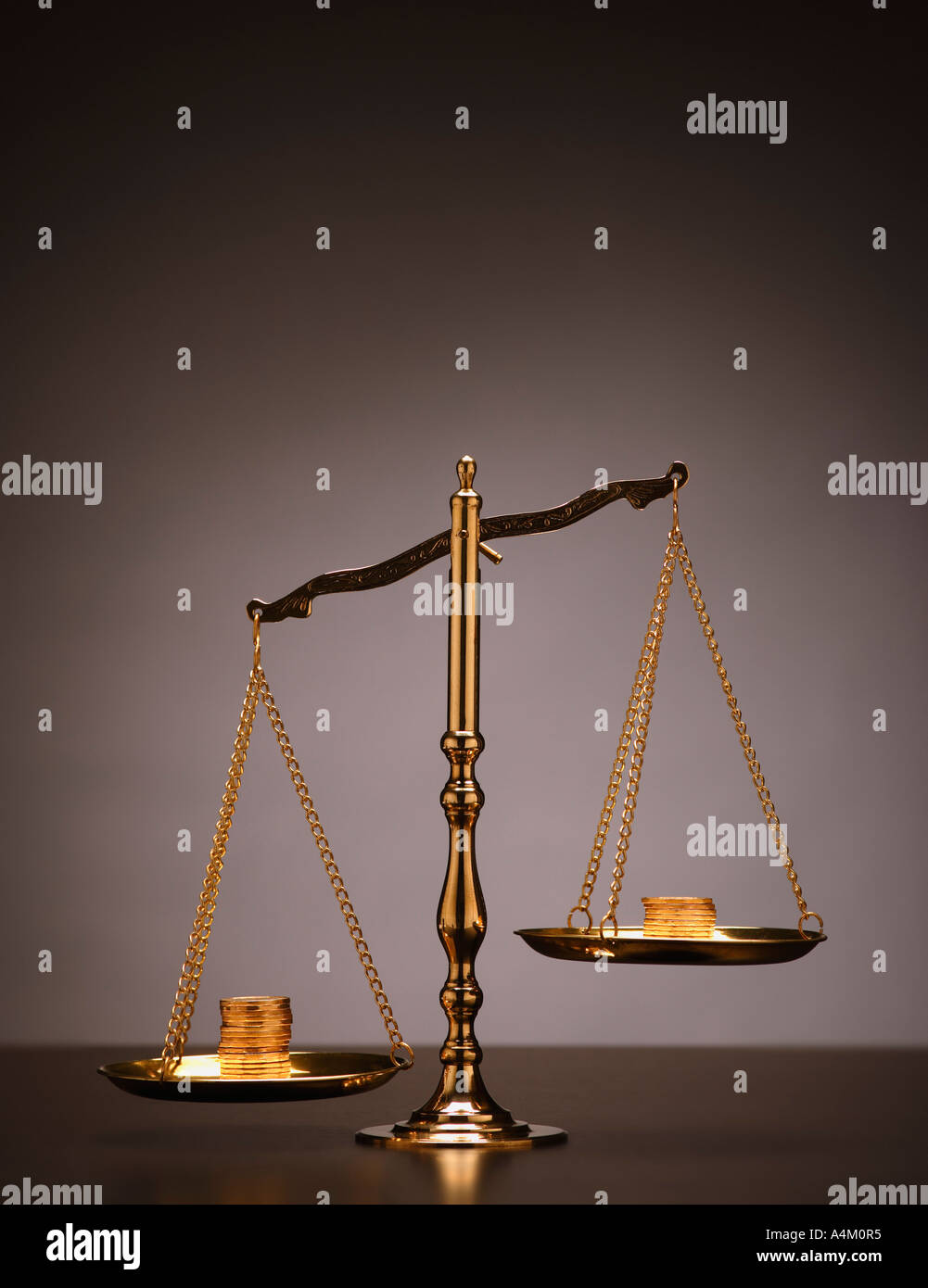 A scale balancing money Stock Photo - Alamy