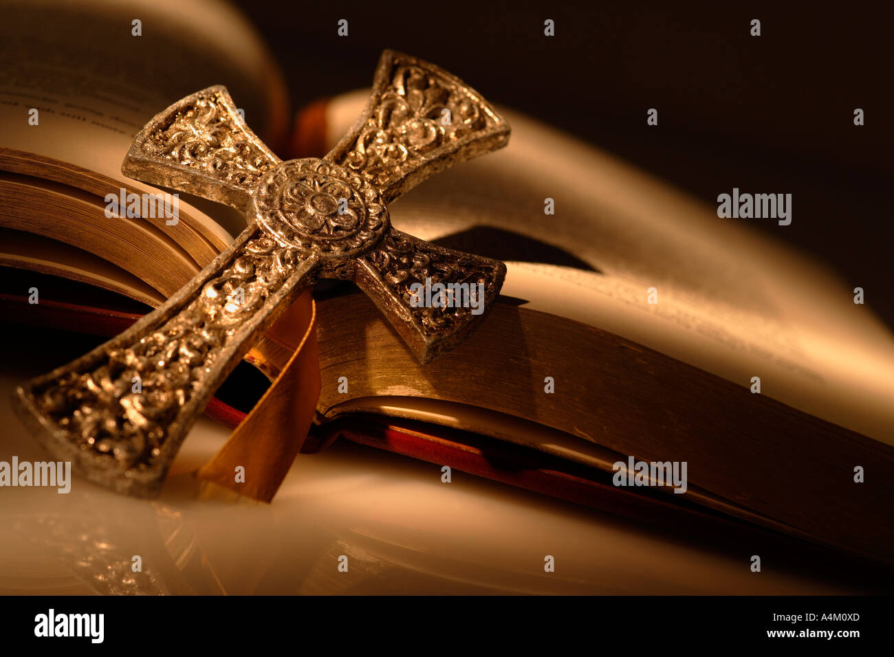 Gold cross on open bible Stock Photo - Alamy