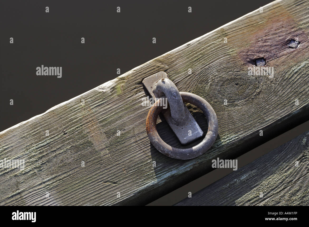 Steel loop for attachment of boats at wooden pier Stock Photo - Alamy