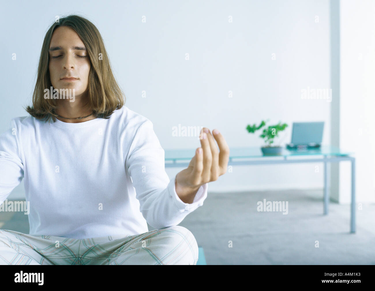 Man sitting in lotus position Stock Photo - Alamy