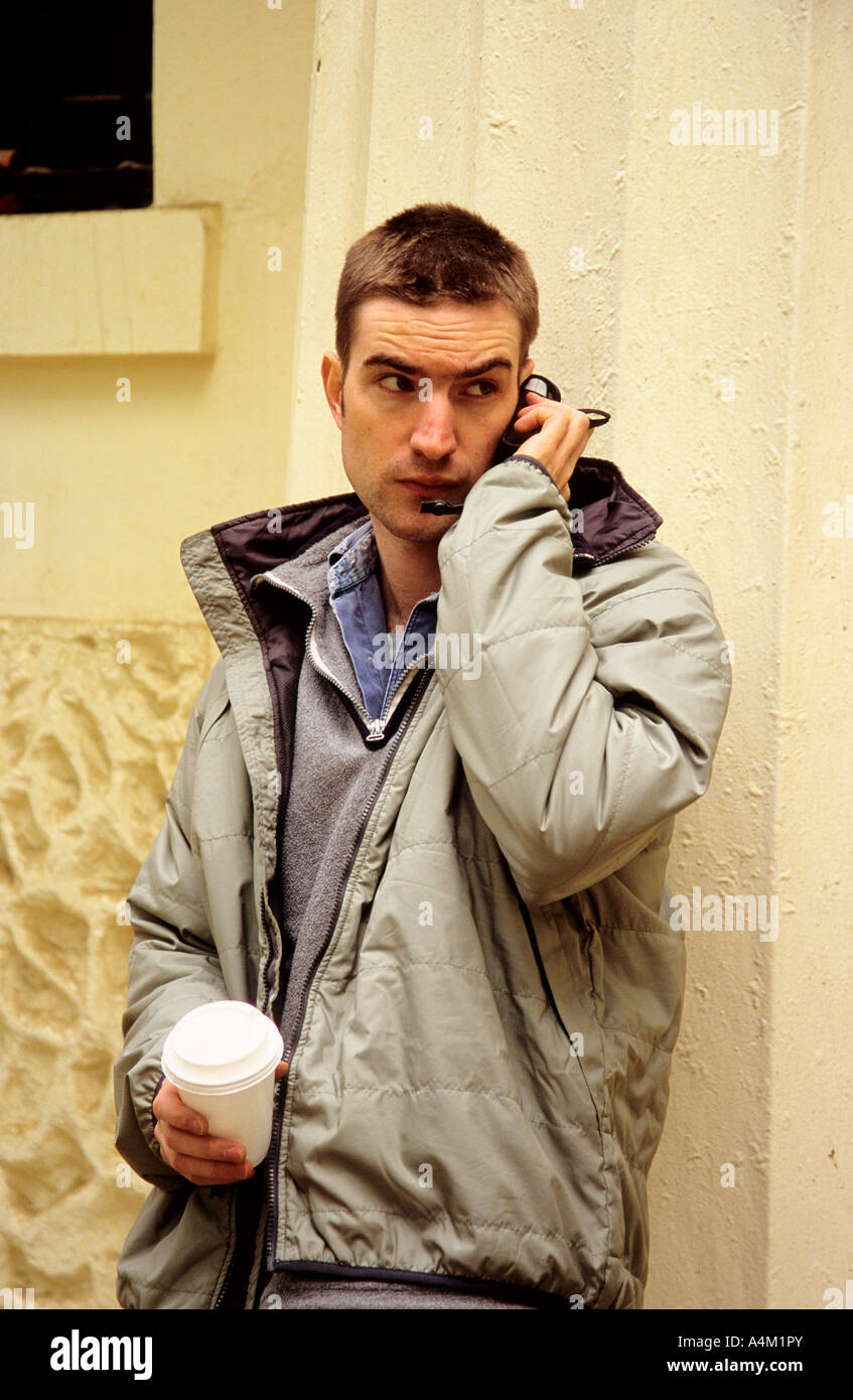 young man telephoning on his mobile home Stock Photo - Alamy