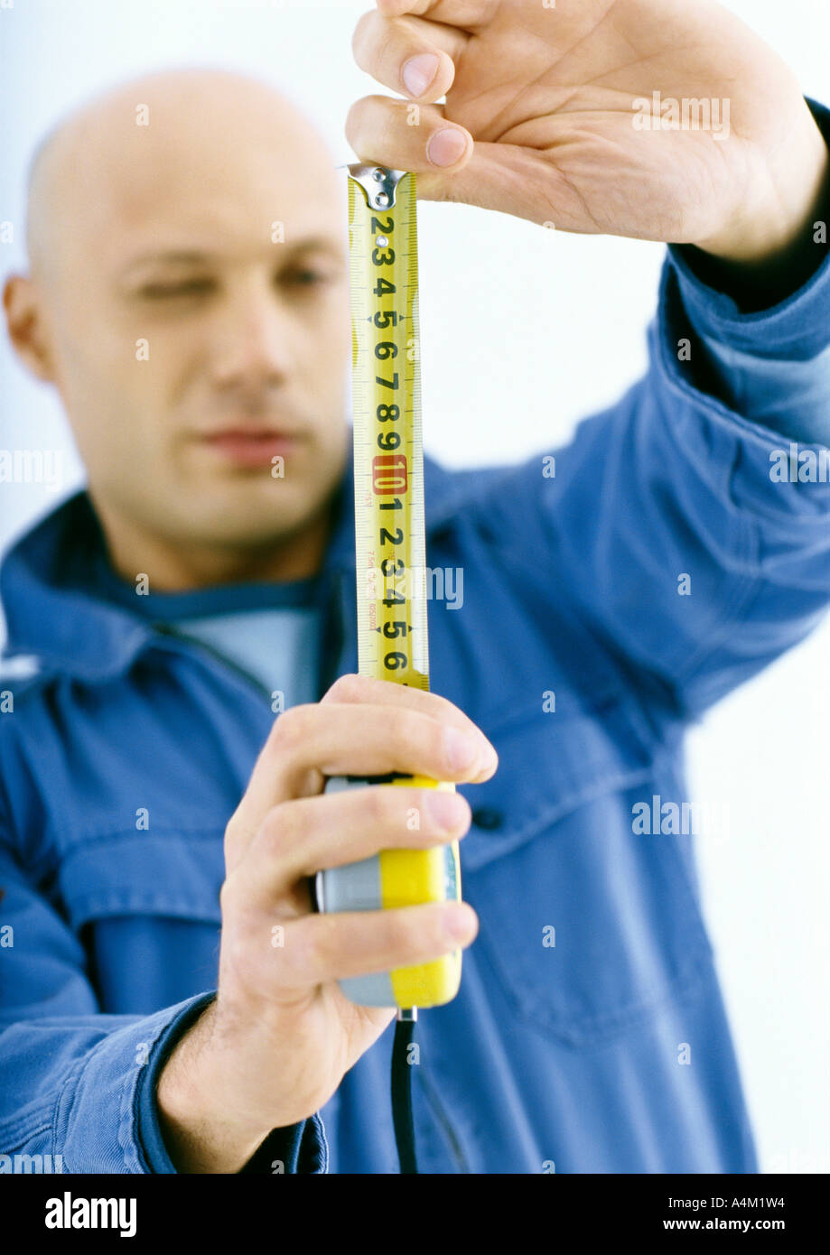 Person Using Measuring Tape The 8 Best Tape Measures, Tested By BHG