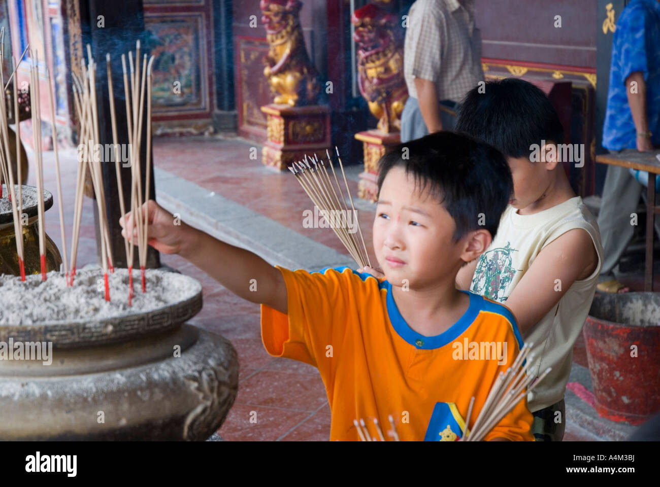 Children burning incense in The Cheng Hoon Teng Temple on Jalan Tokong ...