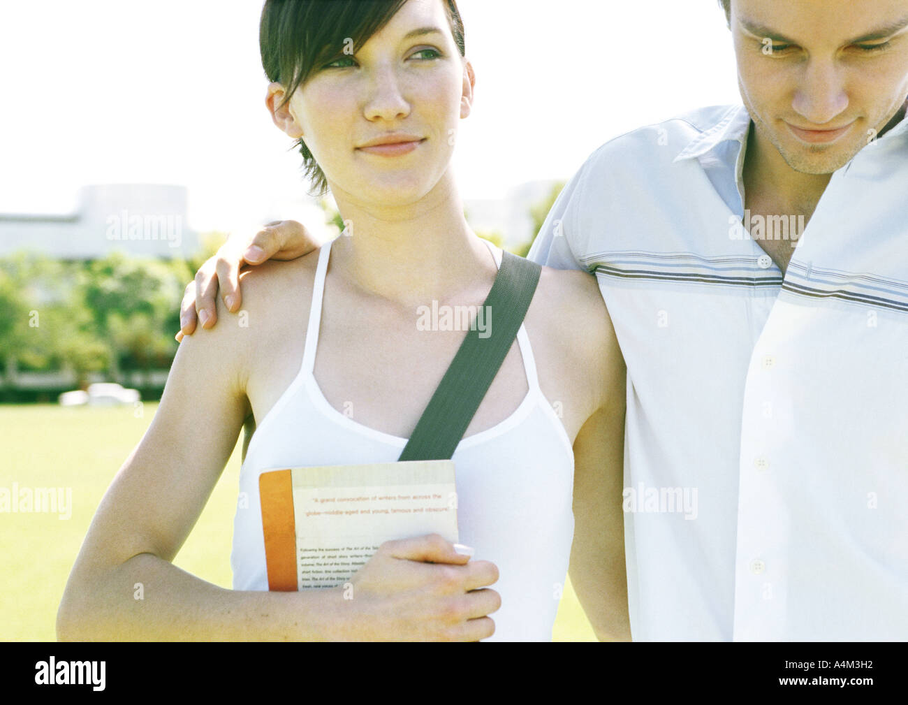 Young couple, man's arm around woman's shoulder Stock Photo - Alamy