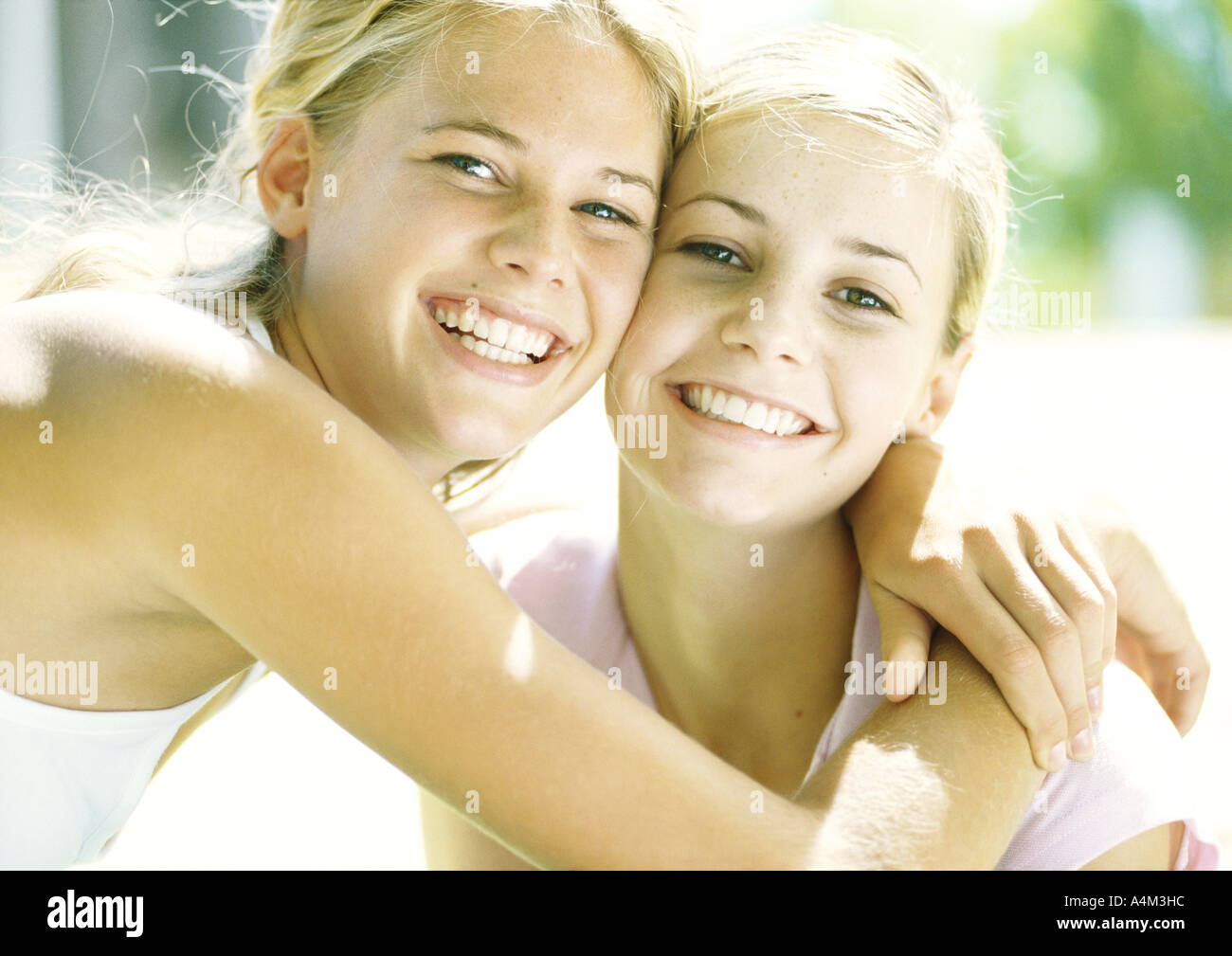 Two teenage girls cheek to cheek, close-up, portrait Stock Photo - Alamy