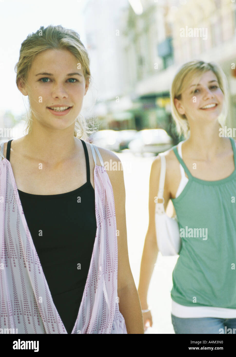 Two teenage girls walking in city Stock Photo - Alamy