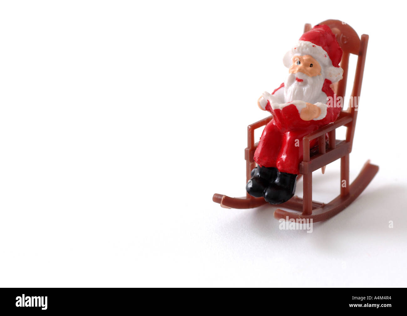Toy Santa Claus in rocking chair Stock Photo - Alamy