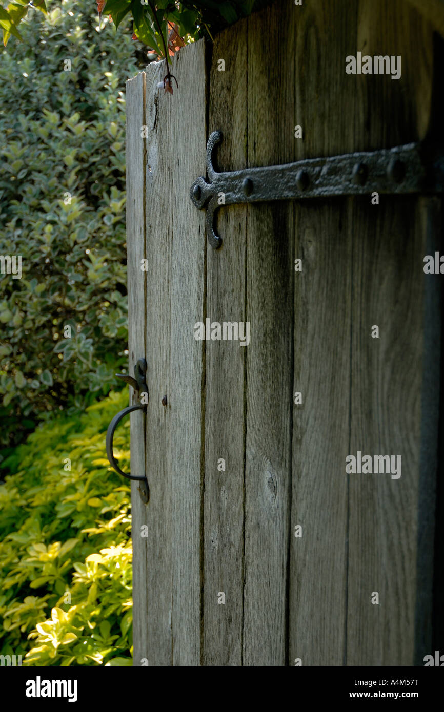 Old wooden door opening into a garden Stock Photo - Alamy