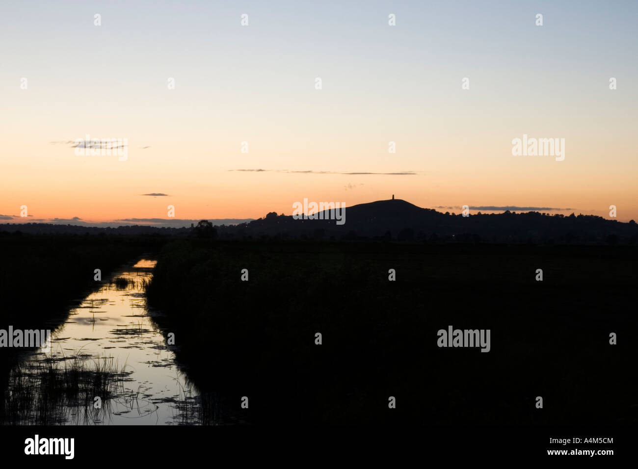 Sunset behind Glastonbury Tor Stock Photo - Alamy