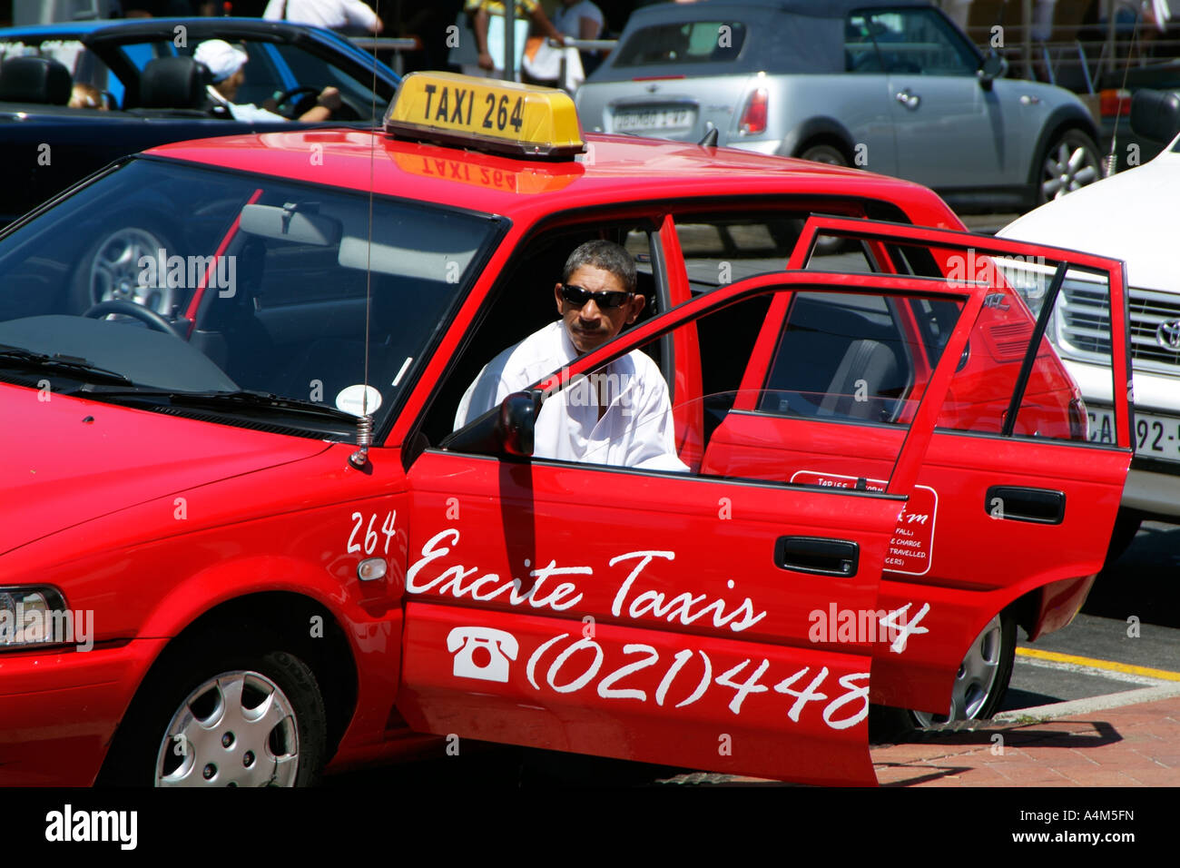 A red taxi for hire on the main street in Camps Bay South Africa RSA ...
