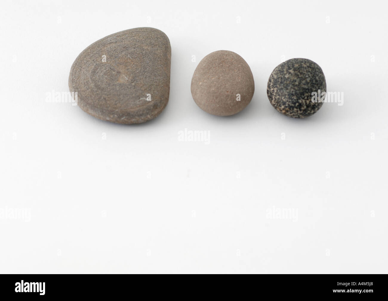 Three stones in a row Stock Photo - Alamy