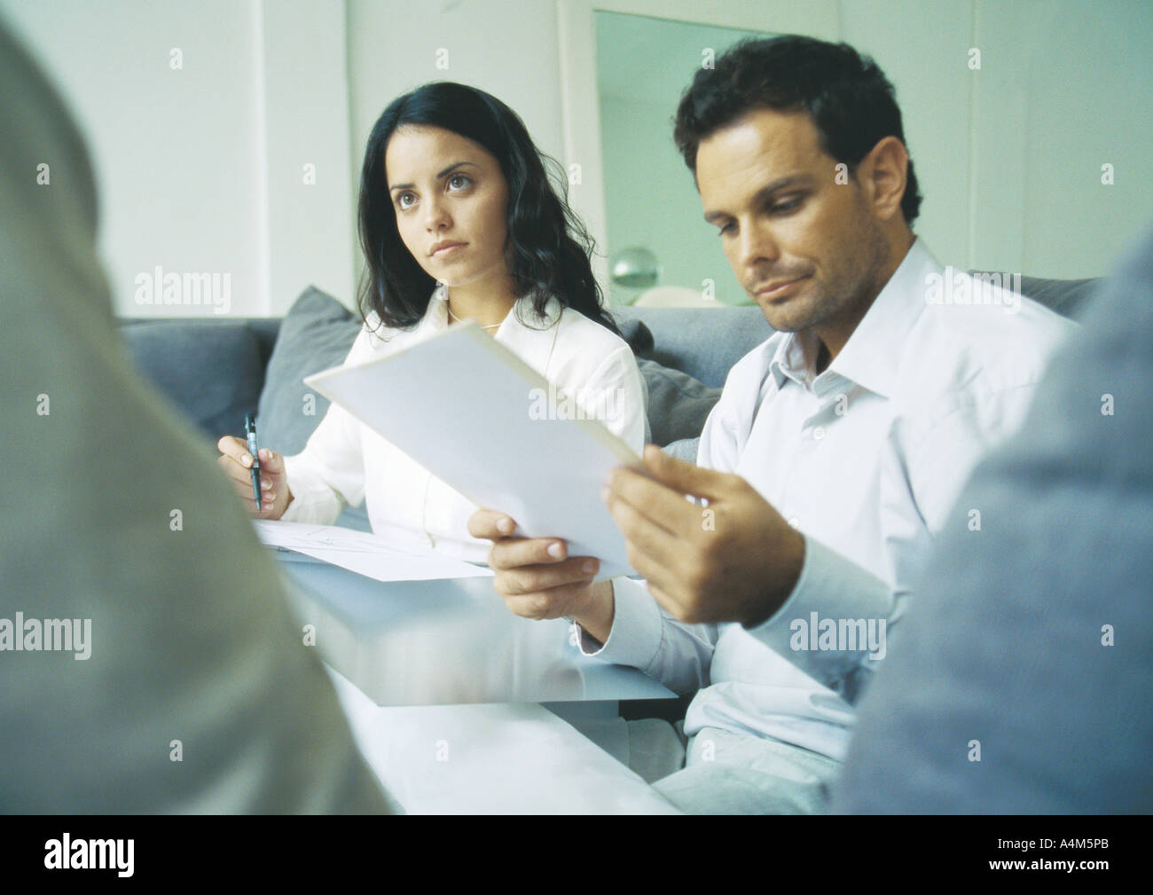 Two businessmen businesswoman examining document hi-res stock ...