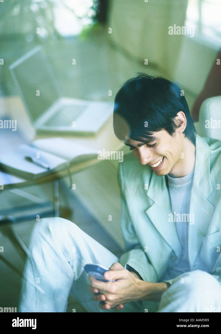 Young man texting messages smiling hi-res stock photography and images ...