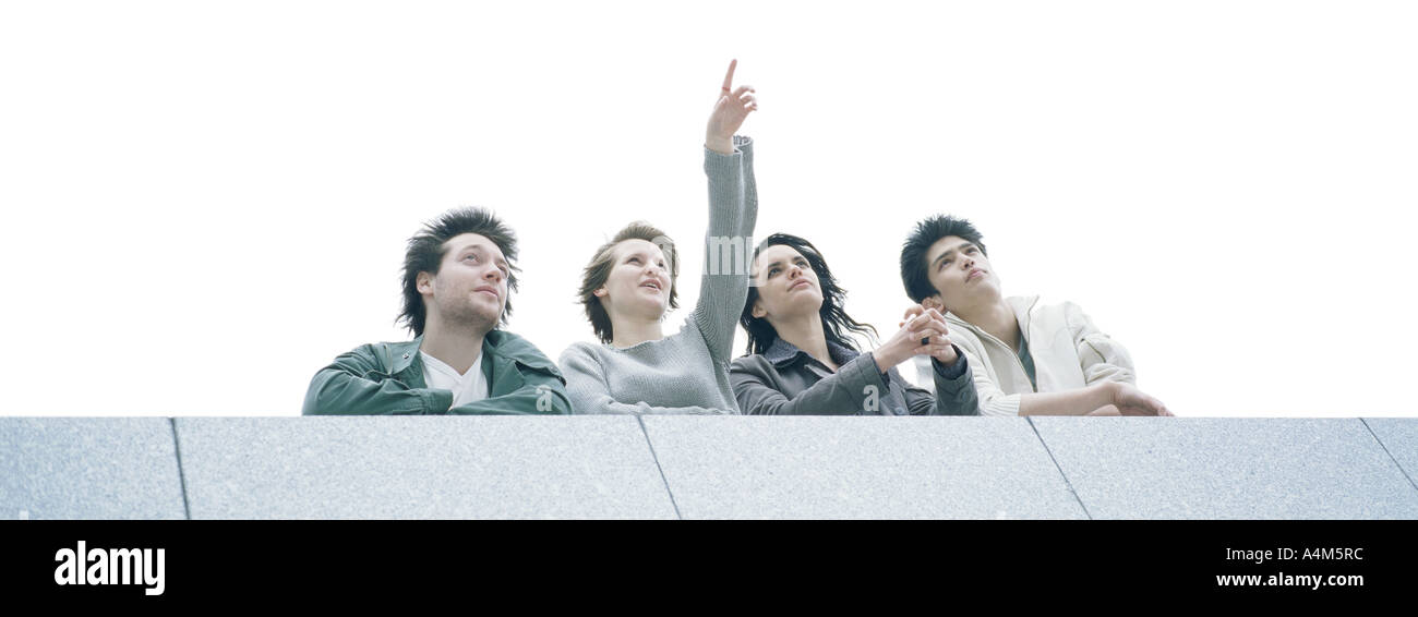Young people at rooftop edge admiring view, low angle view Stock Photo ...