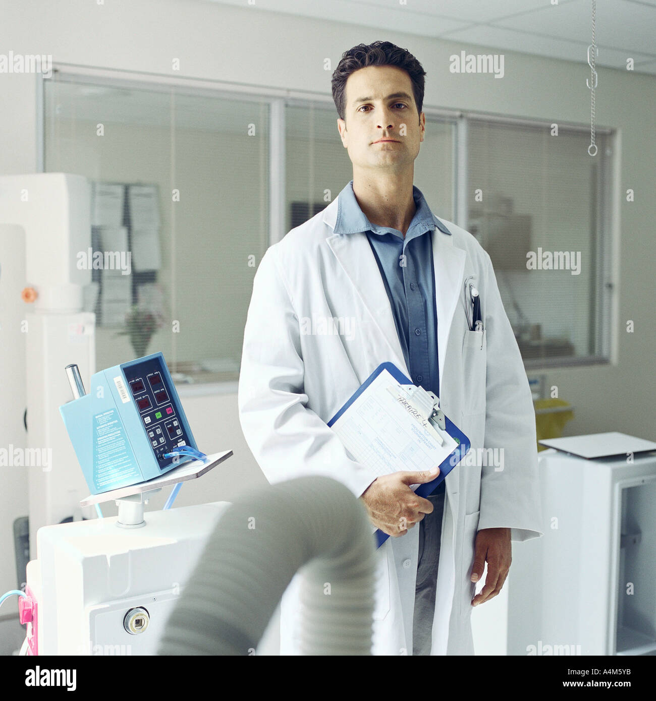 Doctor standing in front of medical equipment Stock Photo - Alamy