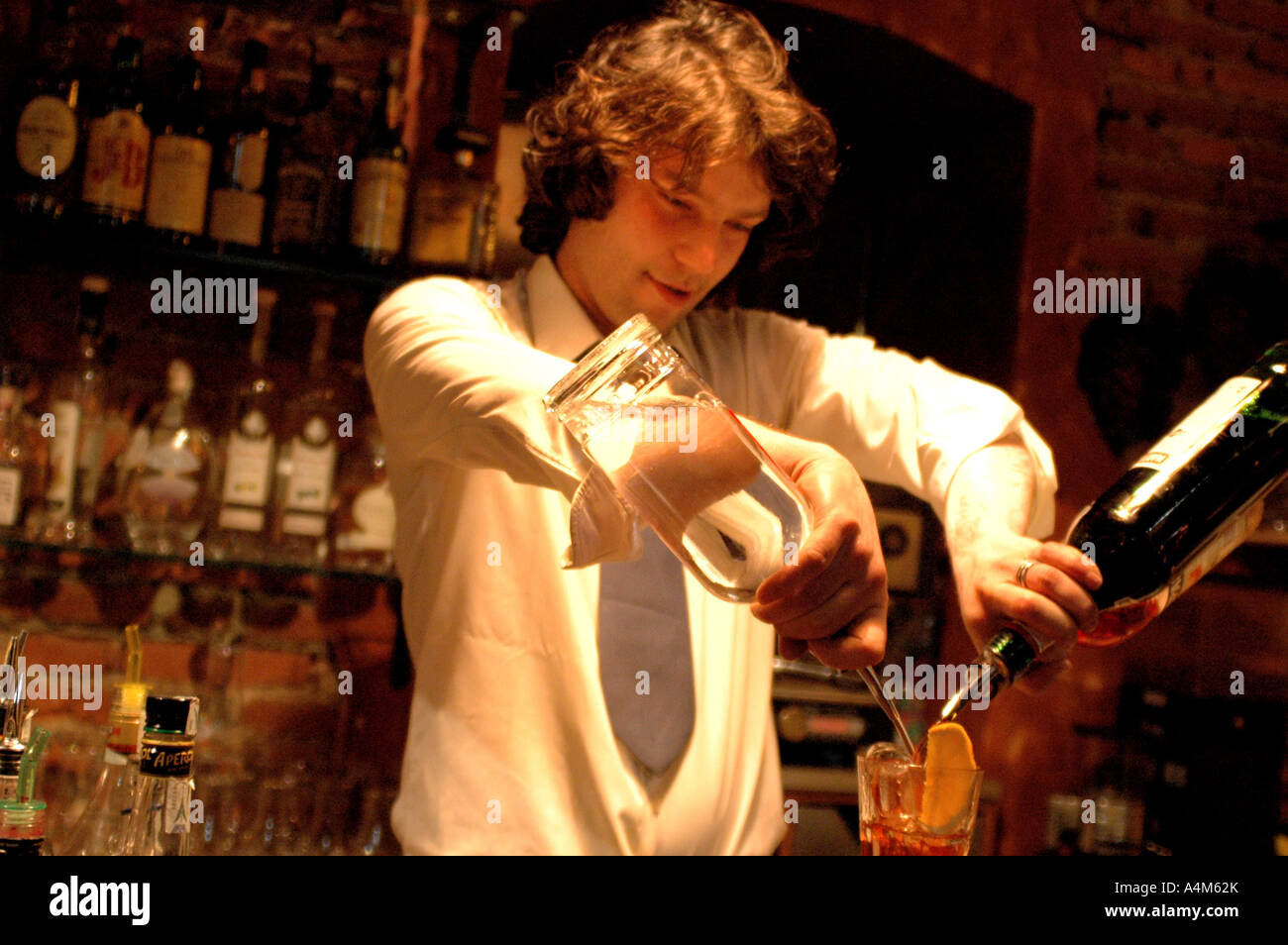 Barman preparing cocktails in a club in the Navigli area in Milan Italy ...