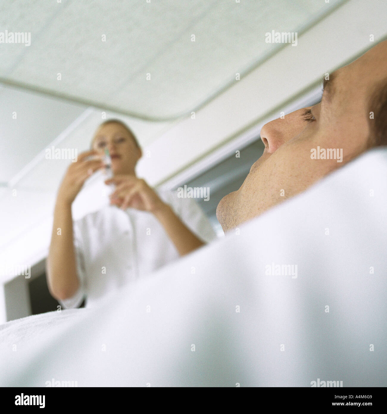 Nurse standing over patient Stock Photo - Alamy