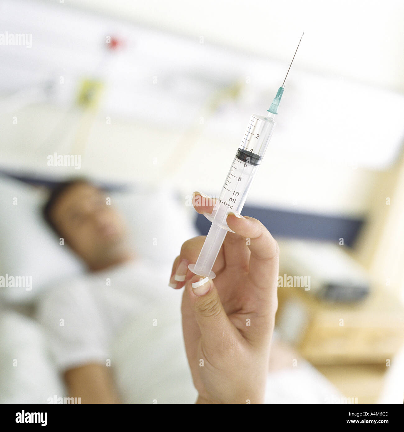 Syringe being held up in front of patient Stock Photo - Alamy