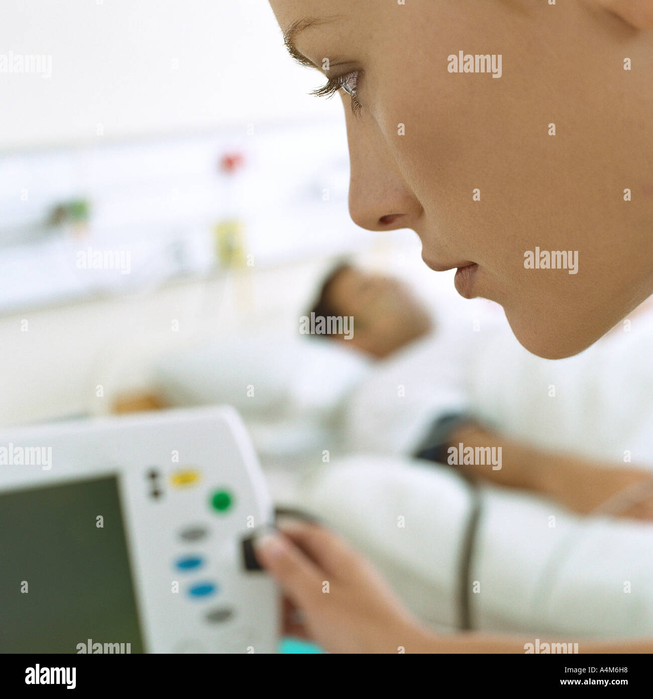 Nurse checking patient's monitor Stock Photo - Alamy