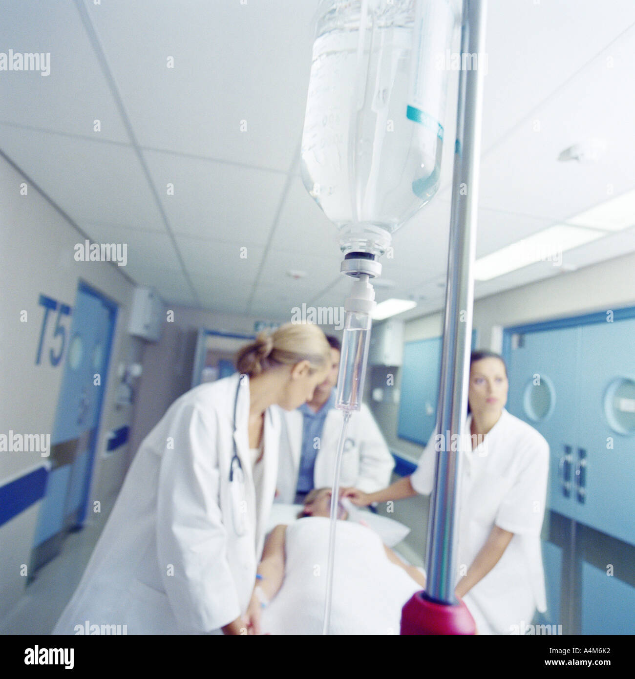 Medical team transporting patient on gurney Stock Photo - Alamy