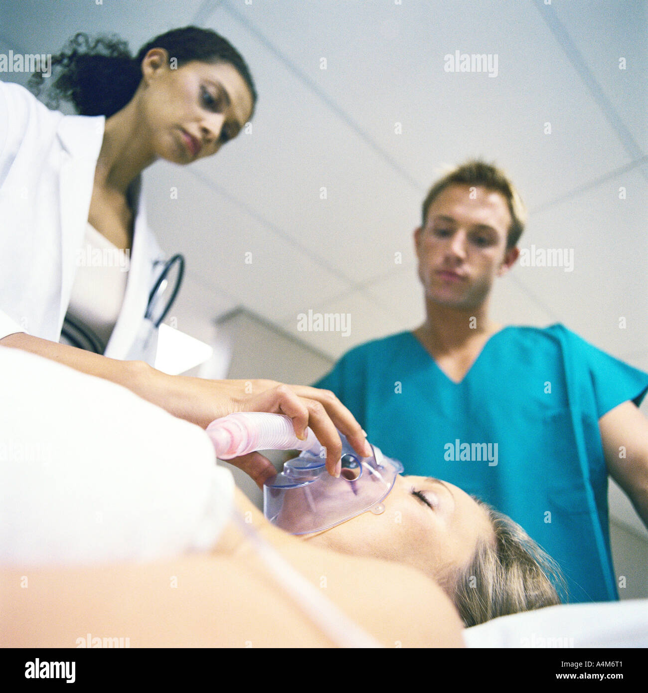 Doctor adjusting patients oxygen mask hi-res stock photography and ...