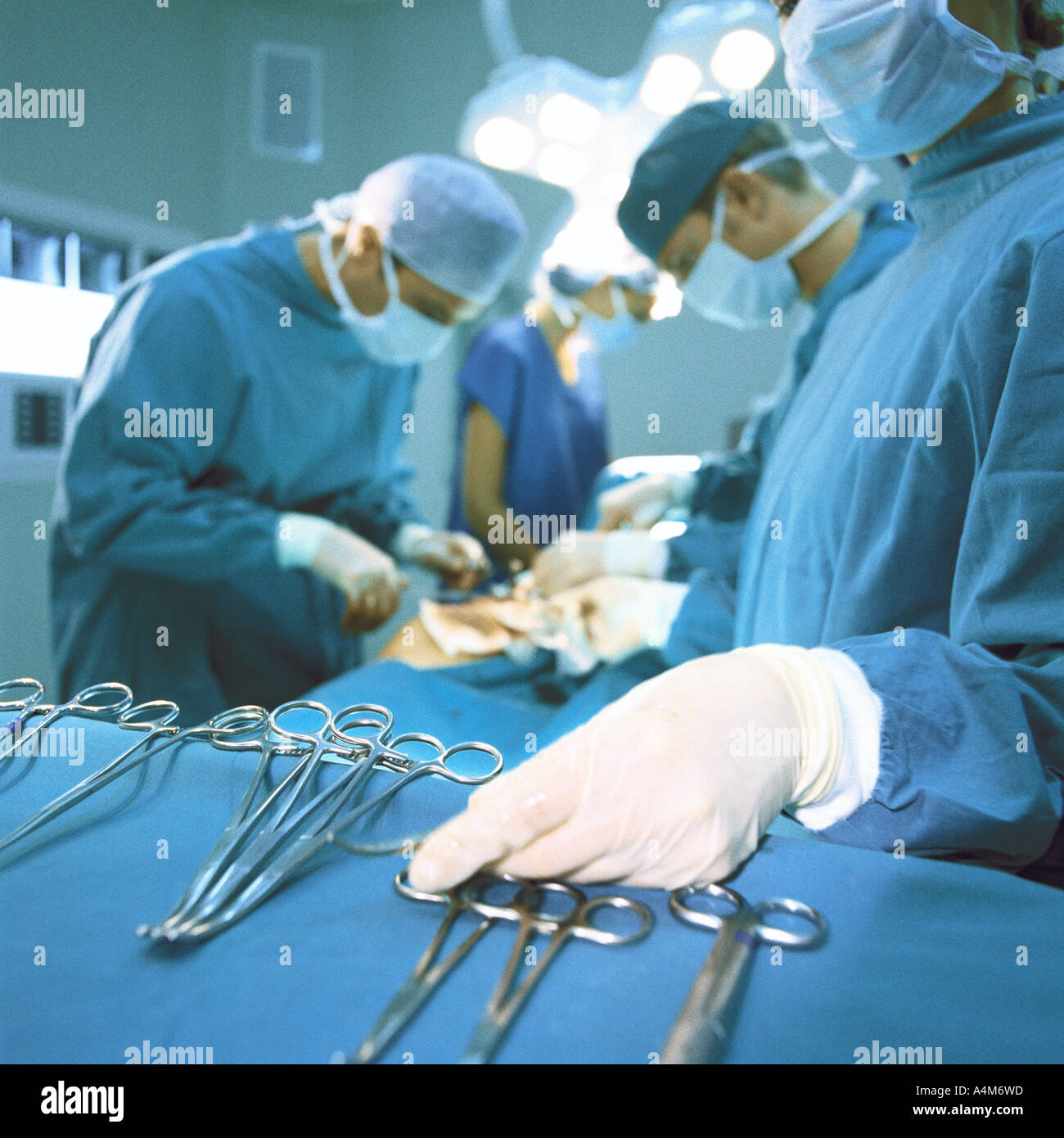 Surgeons team hands performing surgery hi-res stock photography and ...