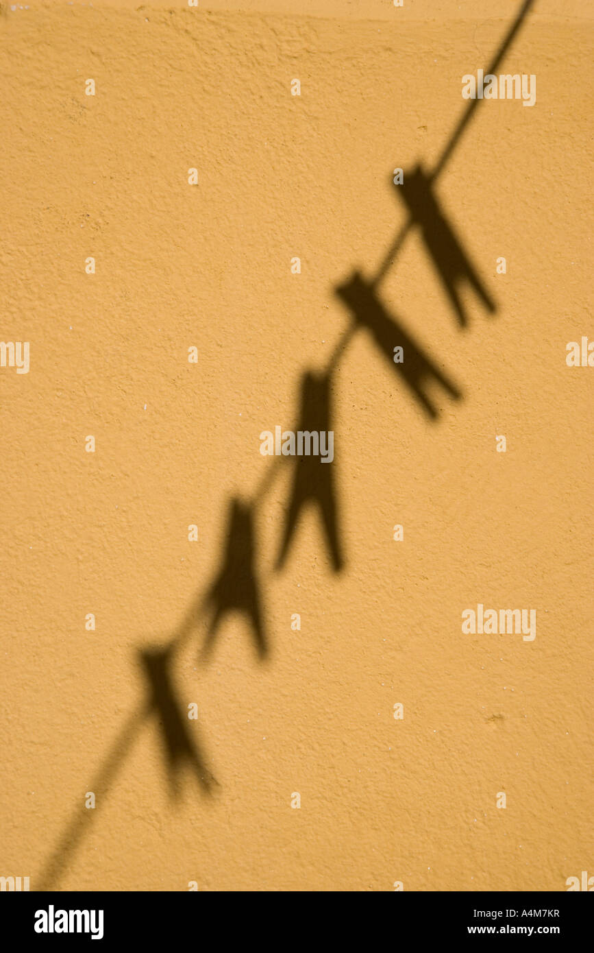 Shadows of pegs on a washing line Stock Photo - Alamy