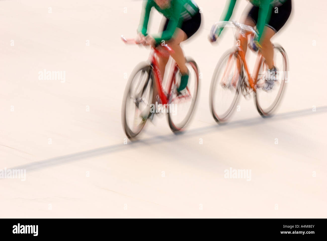 Two cyclists competing in a race at a velodrome Stock Photo - Alamy