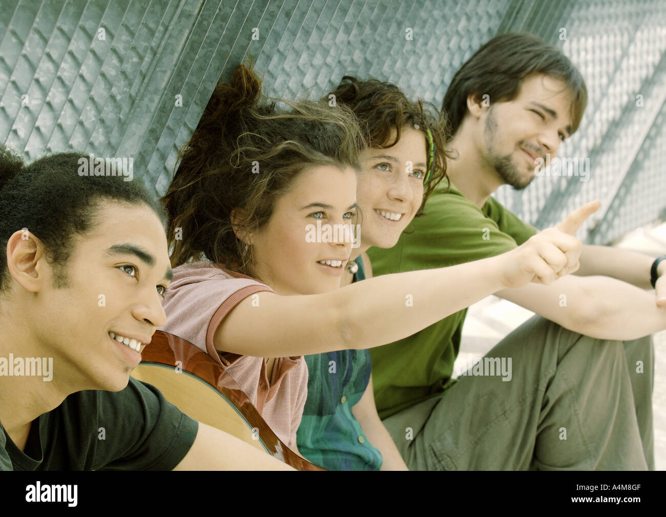 Group of friends, one pointing Stock Photo - Alamy