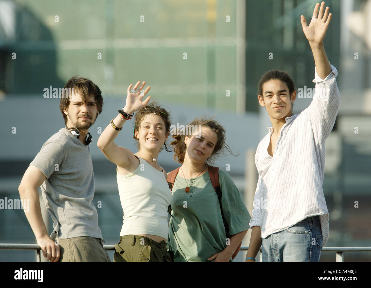 Group of young people waving Stock Photo - Alamy