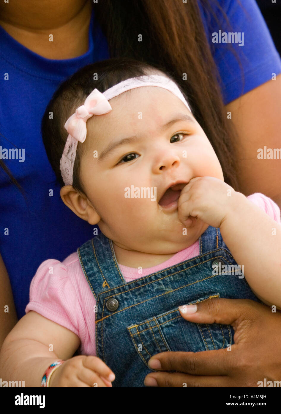 A Native American baby girl sitting on her mother's lap Stock Photo - Alamy