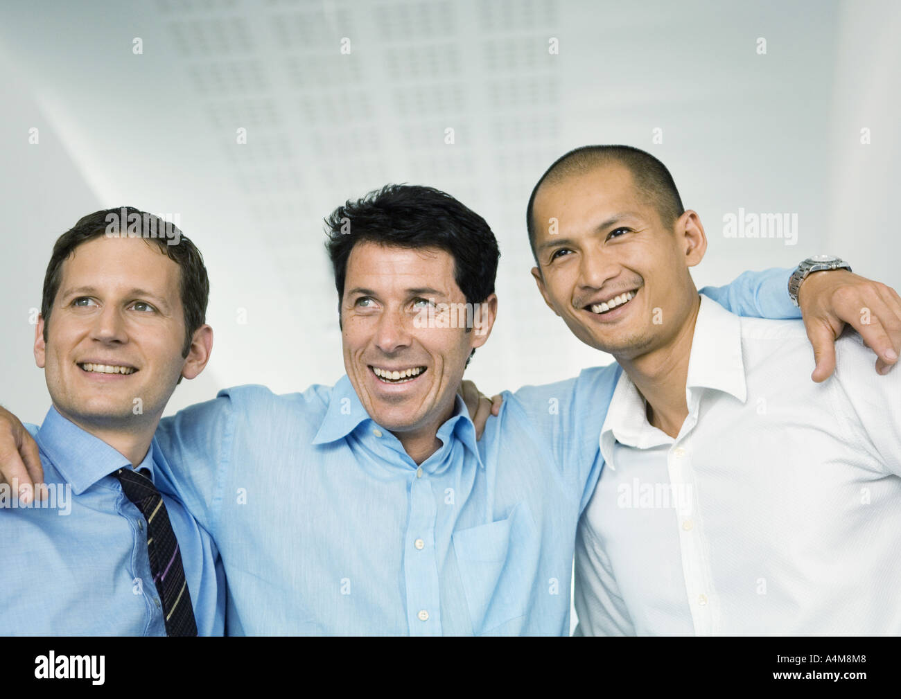Three businessmen with arms around each others' shoulders Stock Photo ...