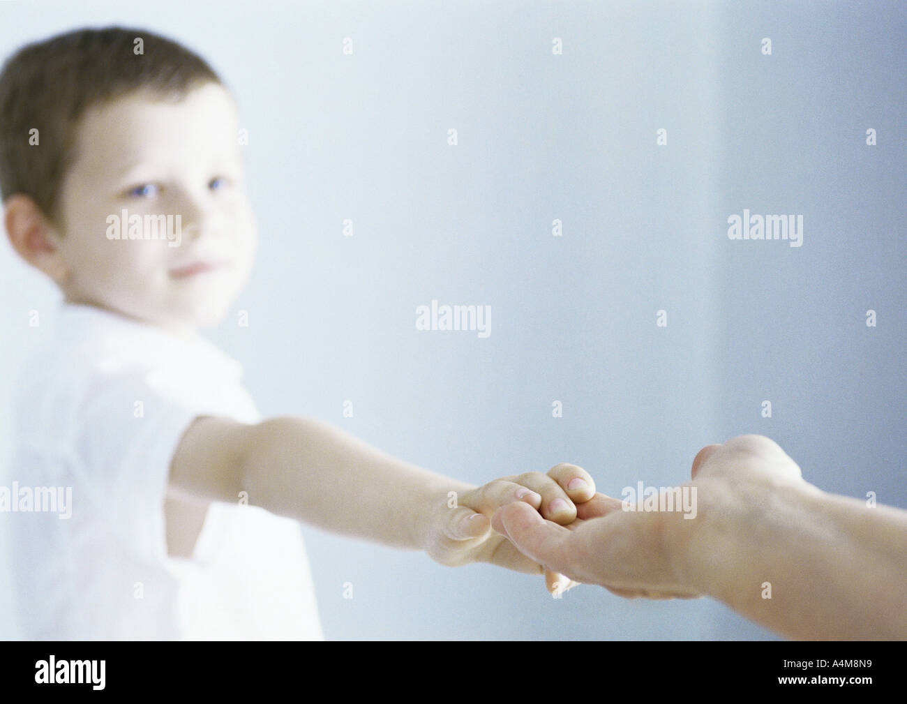 Boy reaching out touch adults hi-res stock photography and images - Alamy