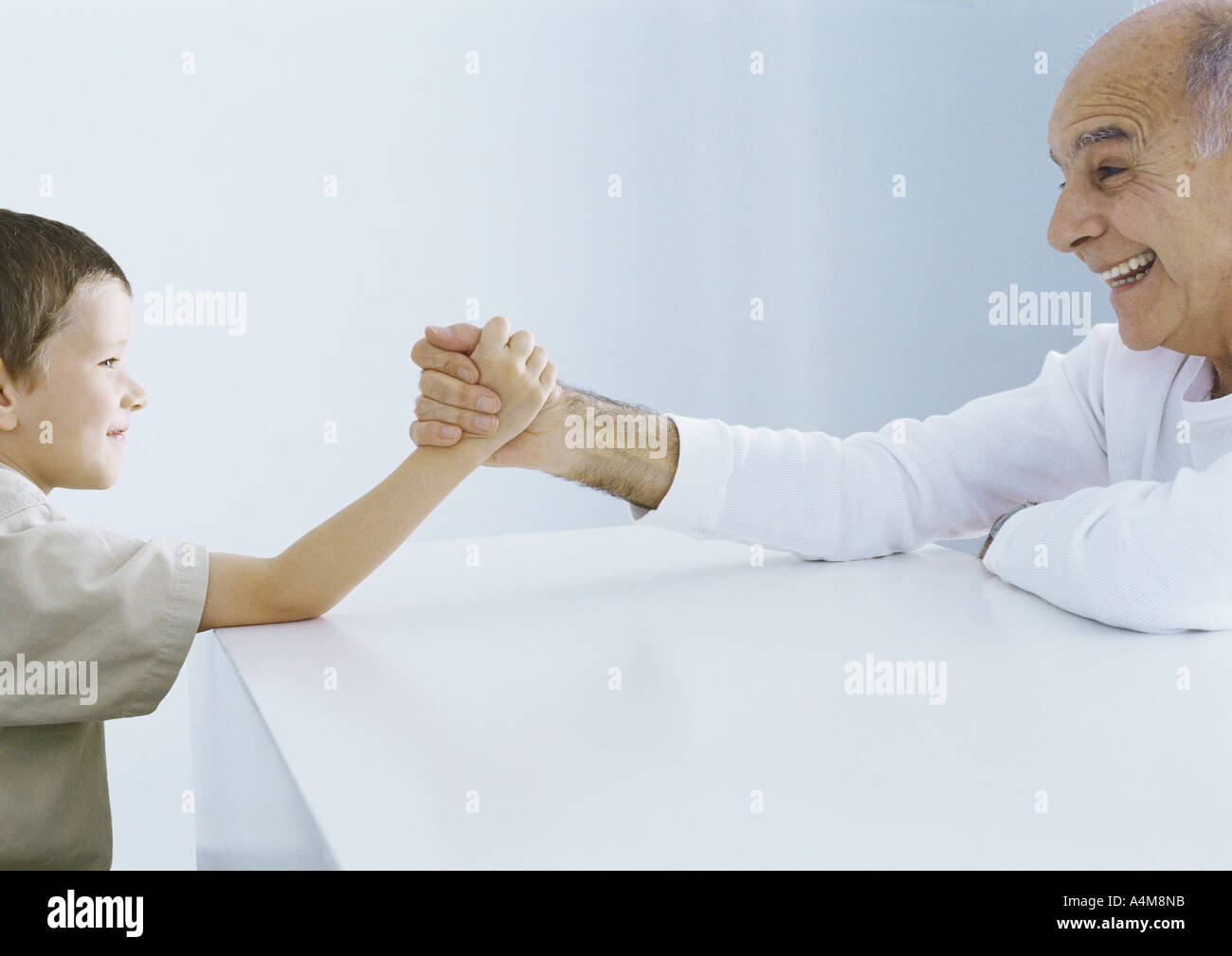 Boy arm wrestling with grandfather Stock Photo - Alamy